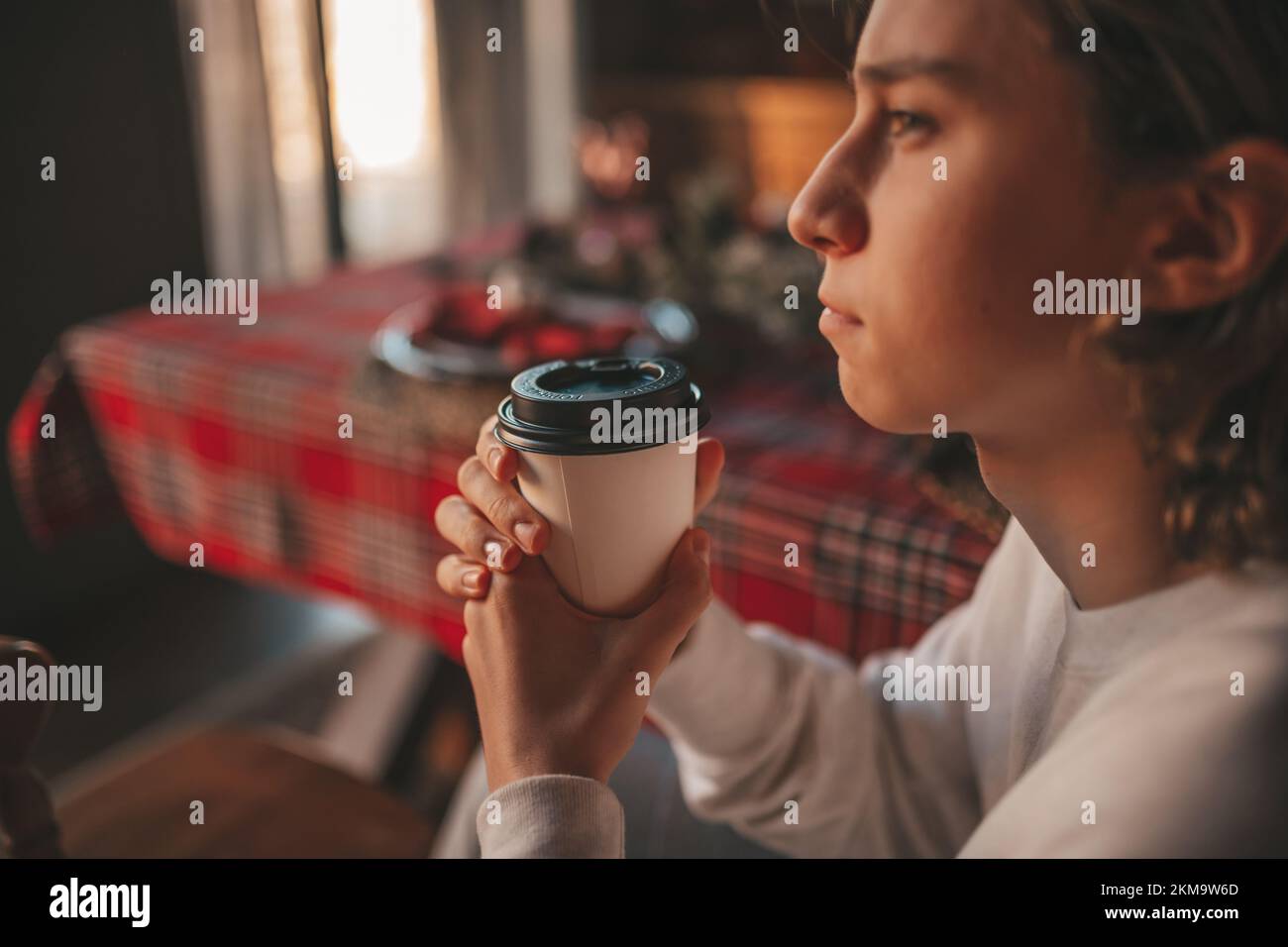 Young teen boy with long hair thoughtful look sad eyes negative mood ...