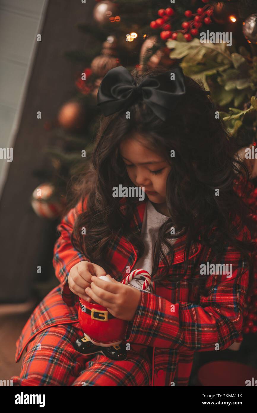 Happy japan little girl dreamer waiting miracle Santa enjoy sweets near ...