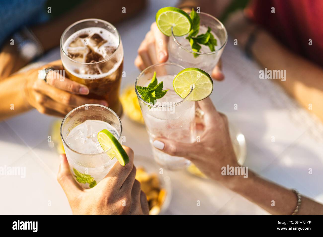 Group of people celebrating toasting with cocktails - cropped detail ...