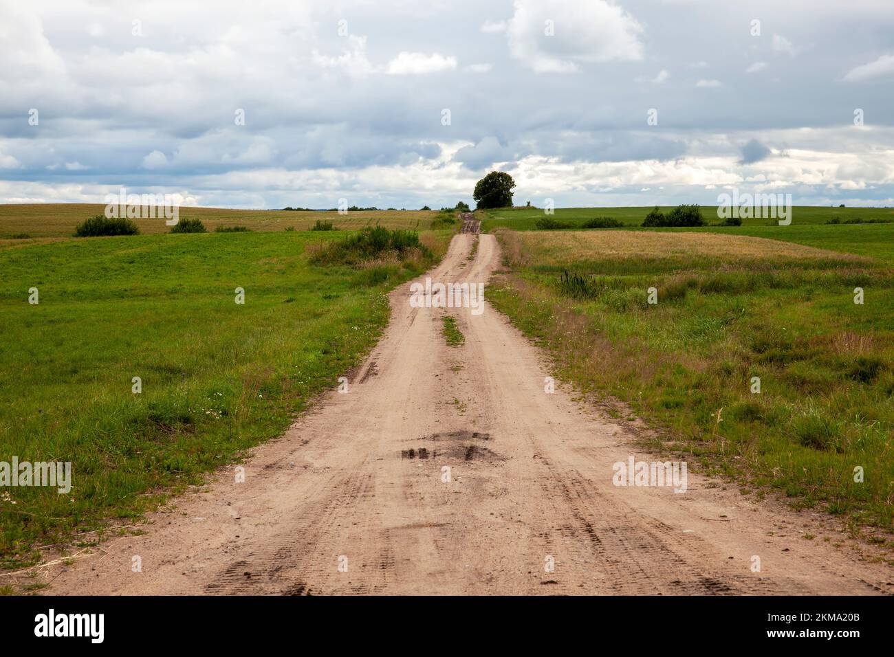 an empty old not paved road , road markings on an not asphalt highway ...