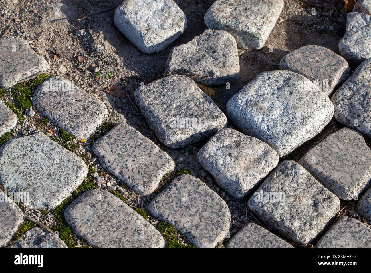 an empty old road made of cobblestones, a highway with a disassembled ...