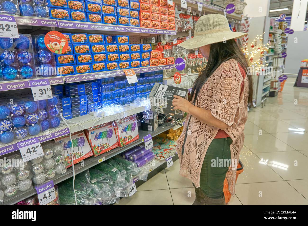 A young woman shopping Christmas decorations at La Torre supermarket ...