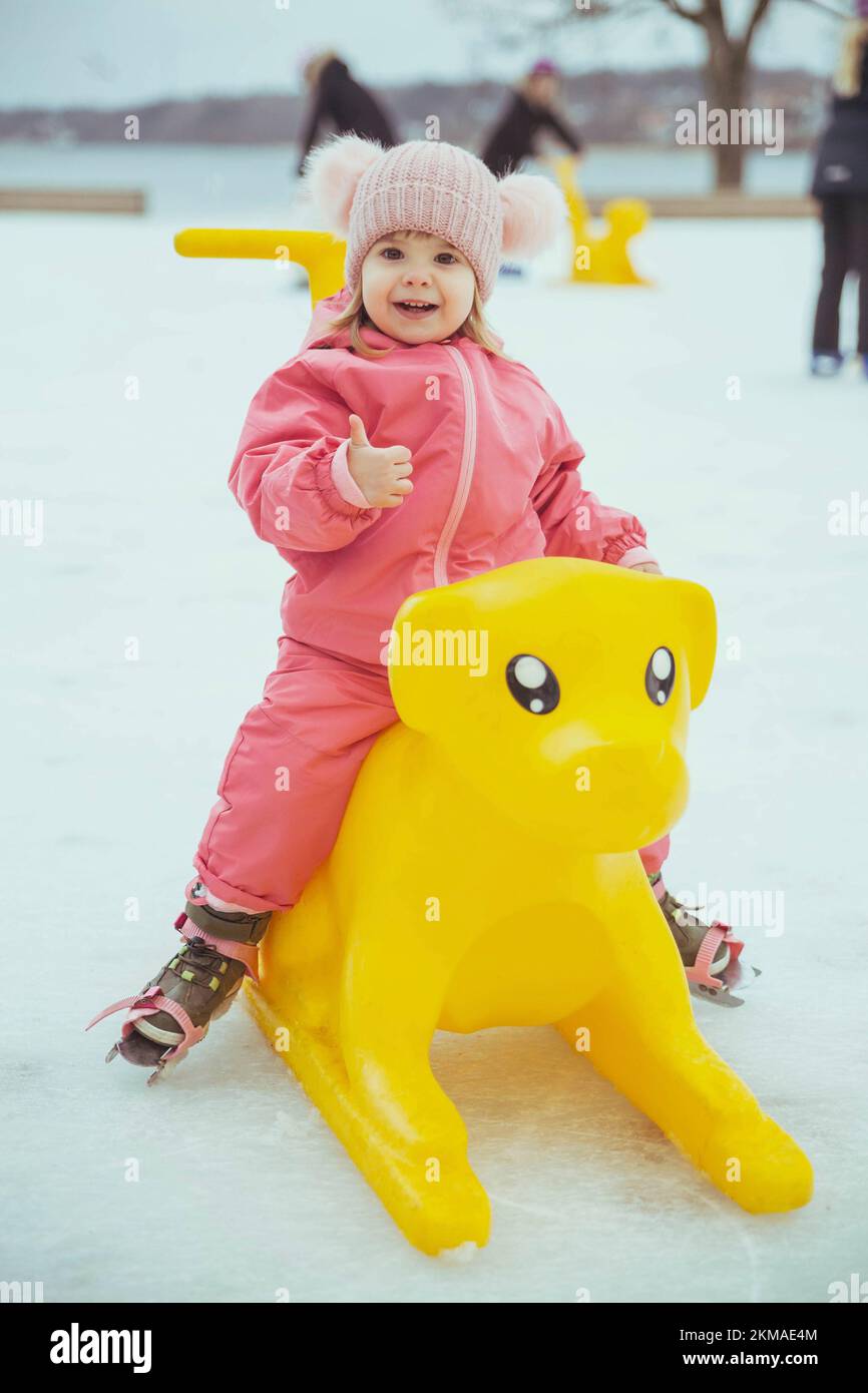 Beautiful baby riding on a sled in the rink in Denmark Stock Photo - Alamy