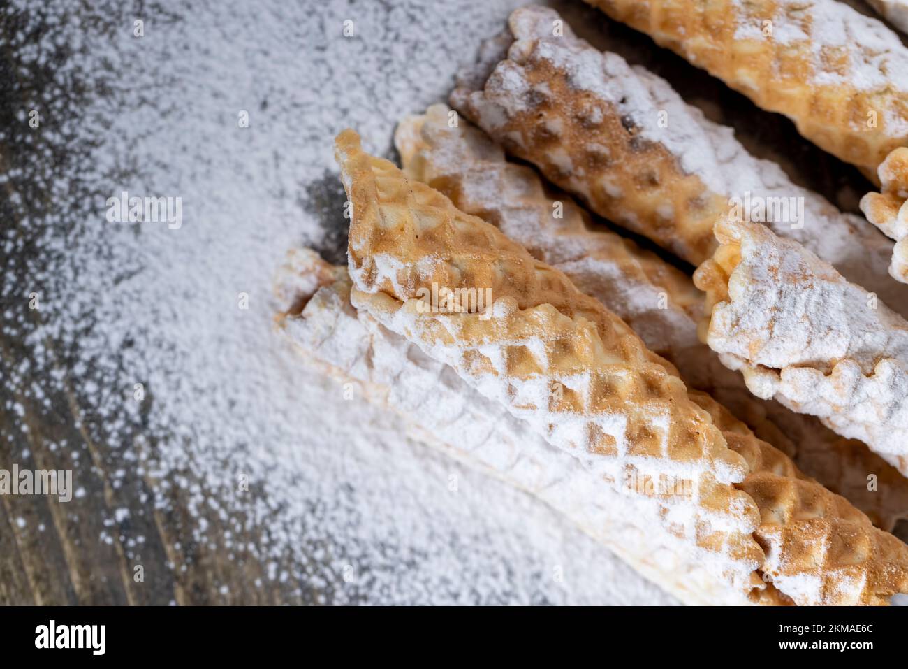thin crispy waffles lie on a black table, sweet food for desserts Stock ...