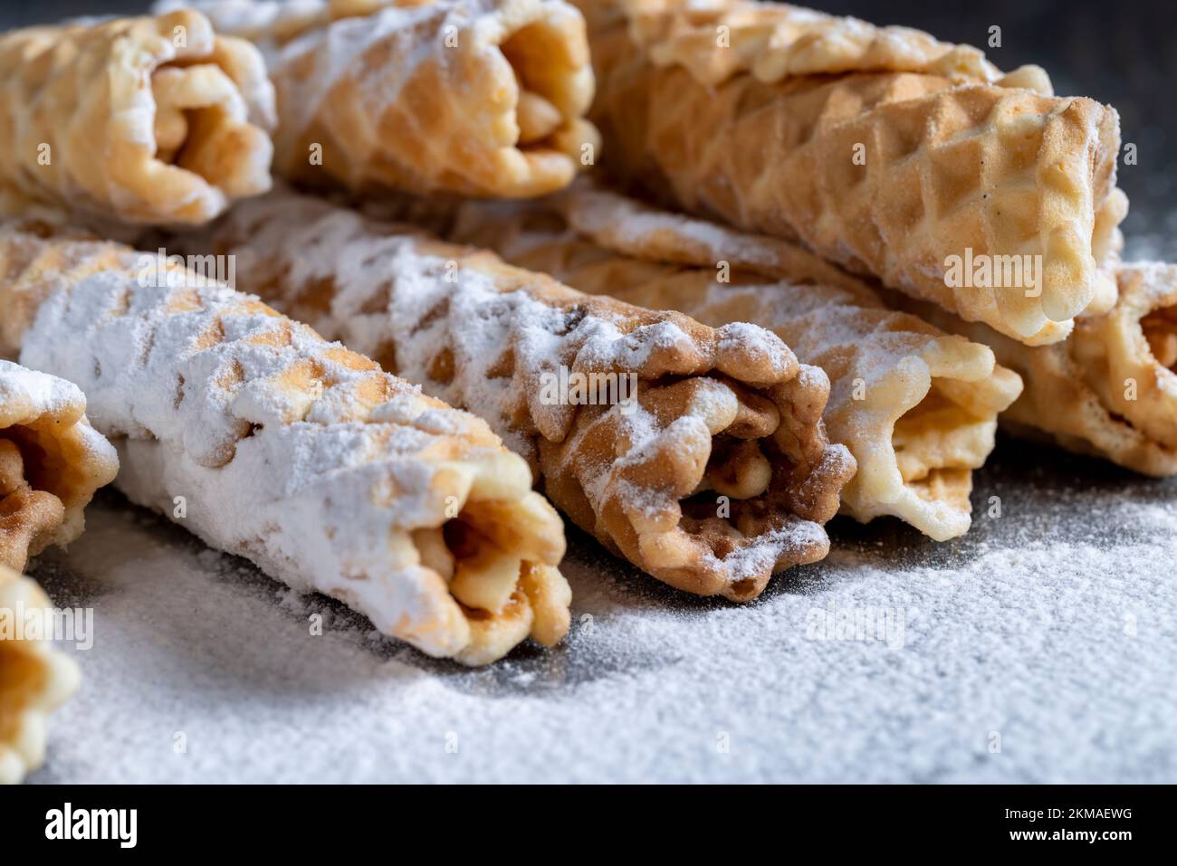 thin crispy waffles lie on a black table, sweet food for desserts Stock ...