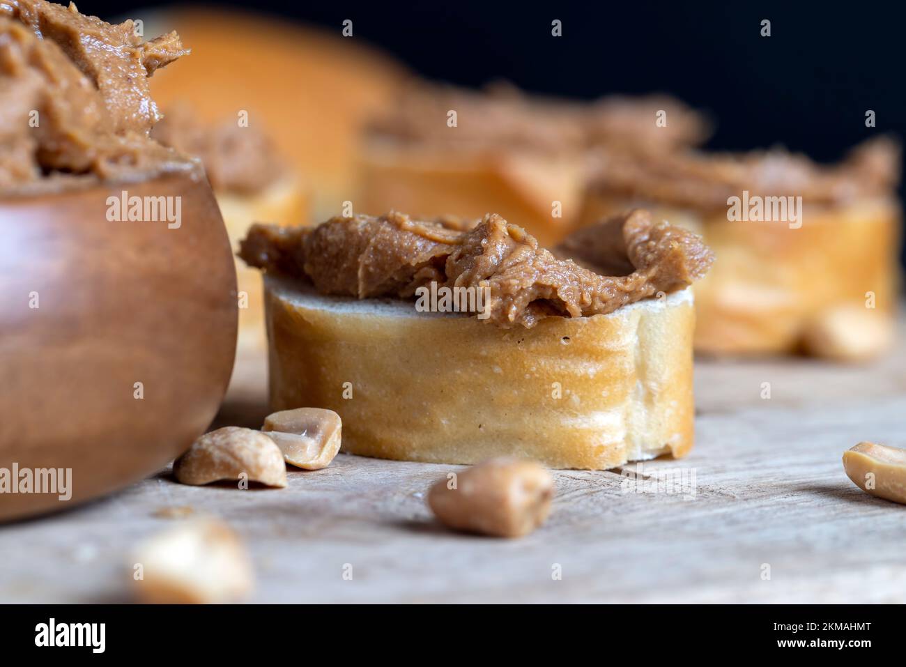 sliced white bread with buttered peanut butter with pieces of crushed ...