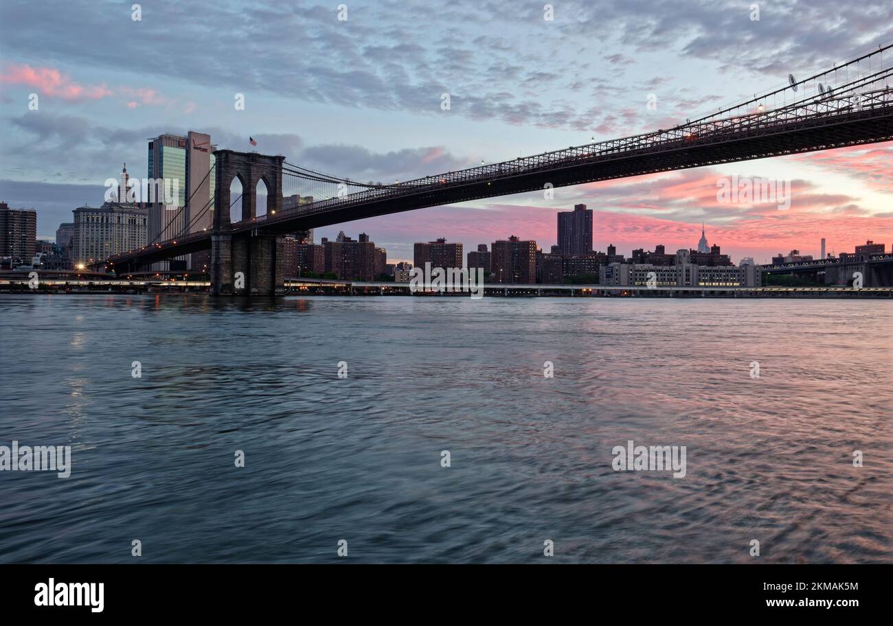 The view of Brooklyn Bridge and East River at sunset. New York City ...