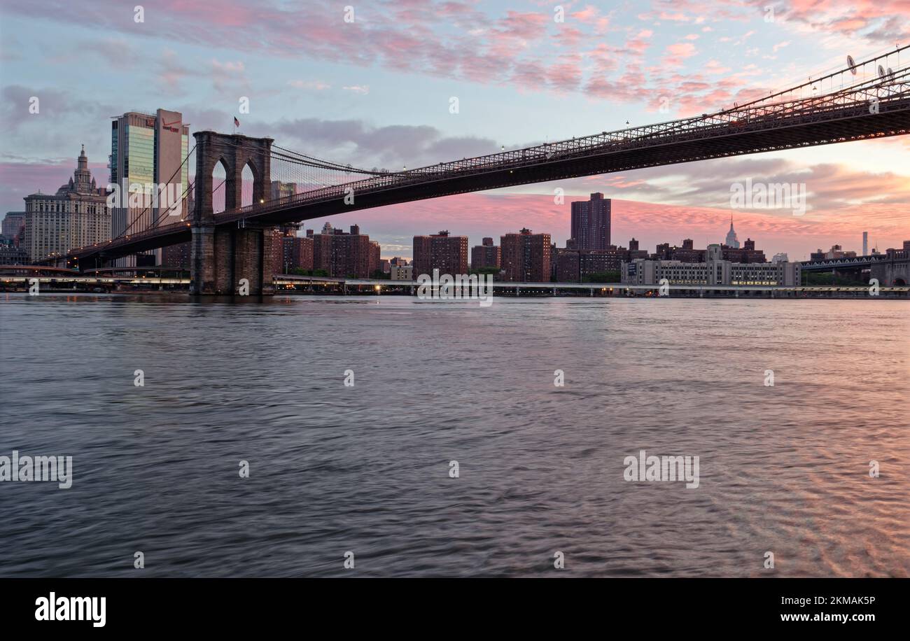 The view of Brooklyn Bridge and East River at sunset. New York City ...