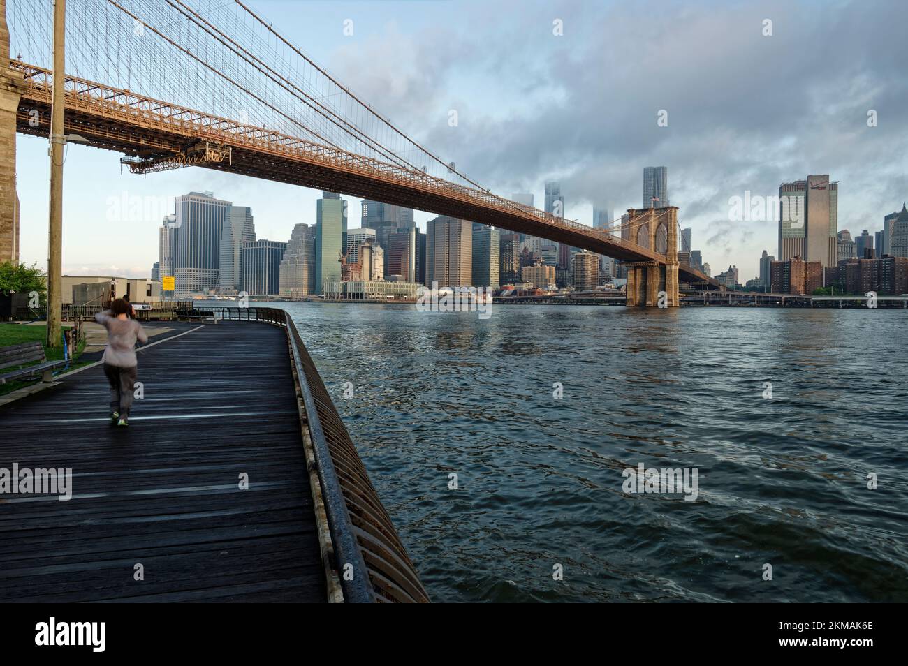 The view of Brooklyn Bridge and East River on a cloudy day. New York ...