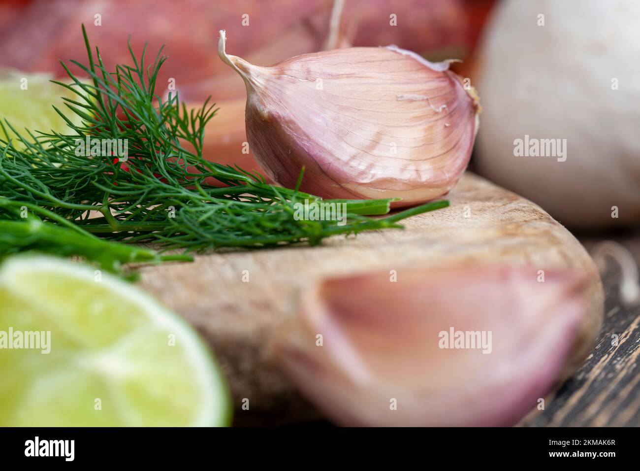 garlic cloves divided into several parts on a cutting board, garlic ...