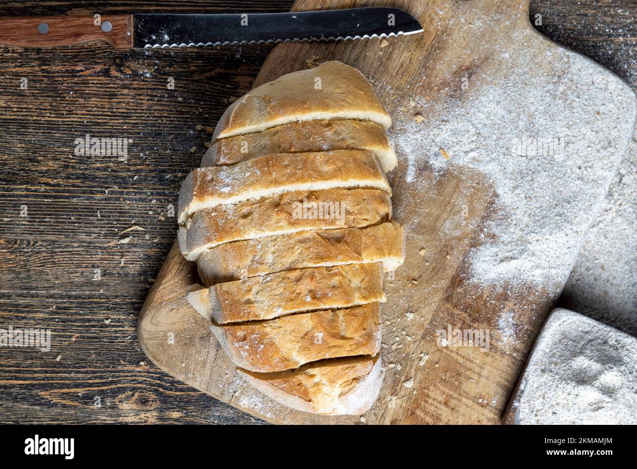 cut fresh bread into pieces while cooking with bread, the bread is cut ...