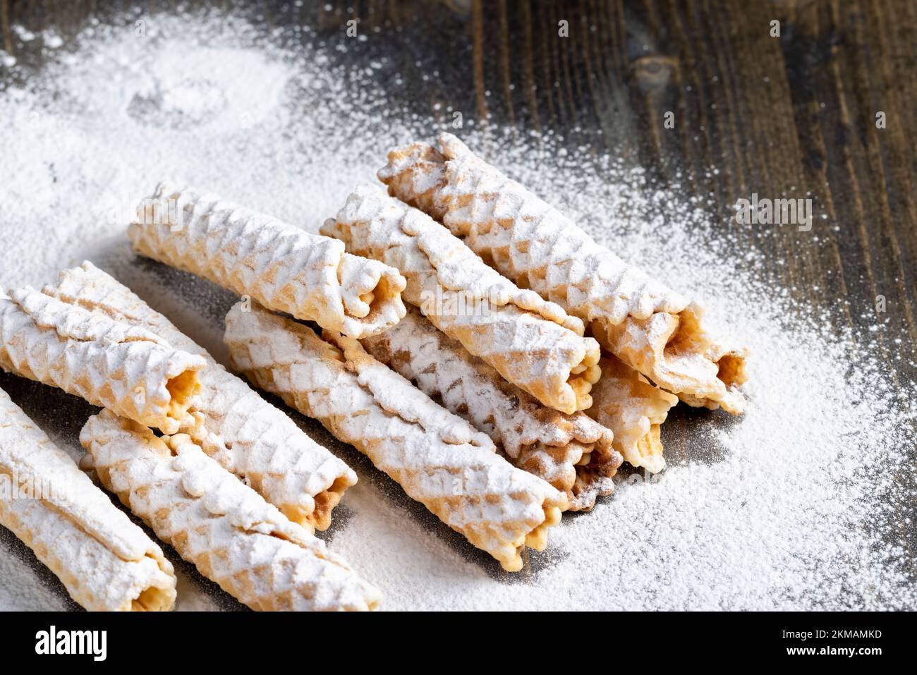 thin crispy waffles lie on a black table, sweet food for desserts Stock ...