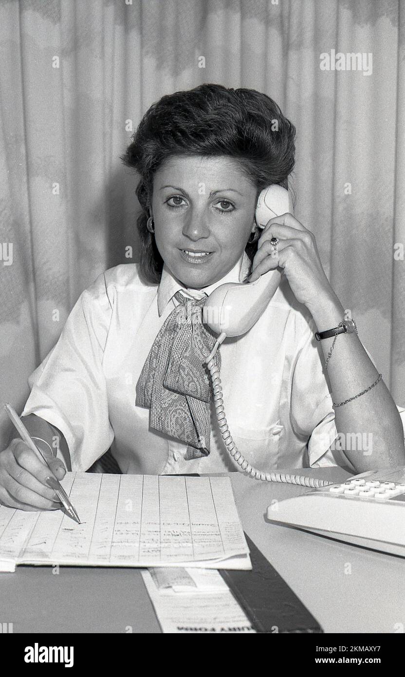 1980s, historical, a sales lady of new homes wearing a blouse, with ...