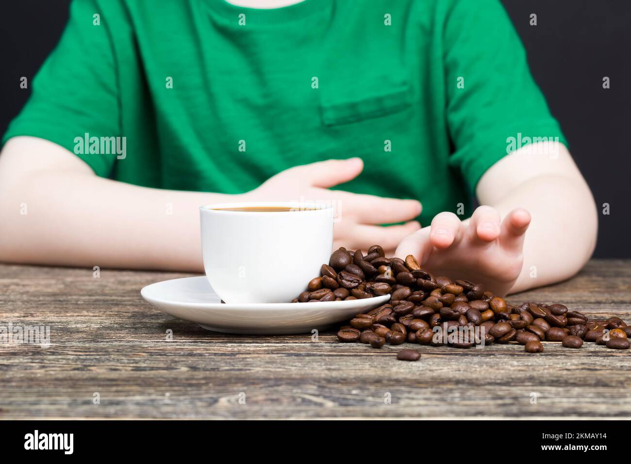 boy drinking tea, coffee beans are lying next to him, a child with food ...
