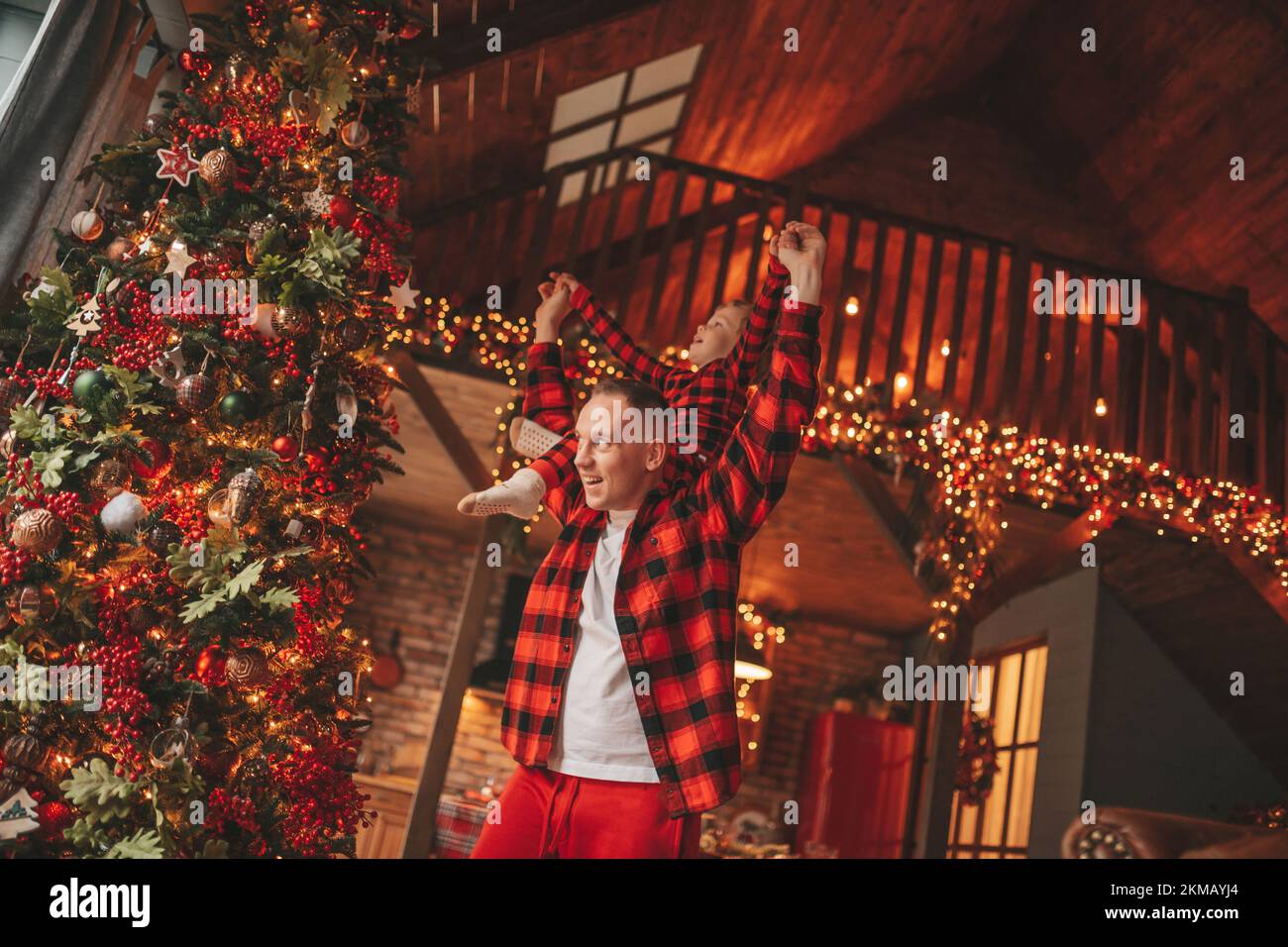 Smile little boy sits on father neck having fun with each other indoor ...
