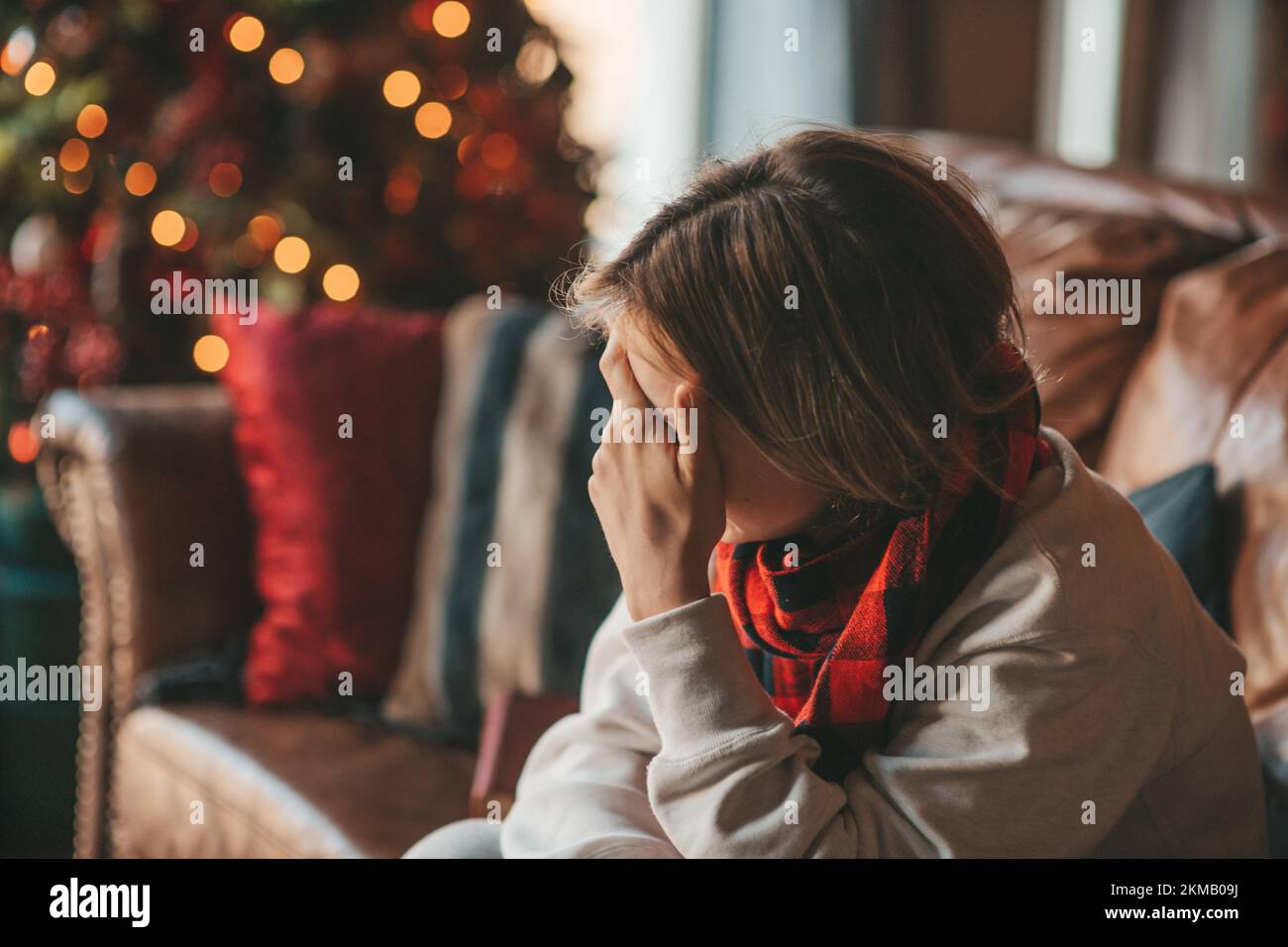 Young teen boy with long hair thoughtful look sad eyes negative mood ...