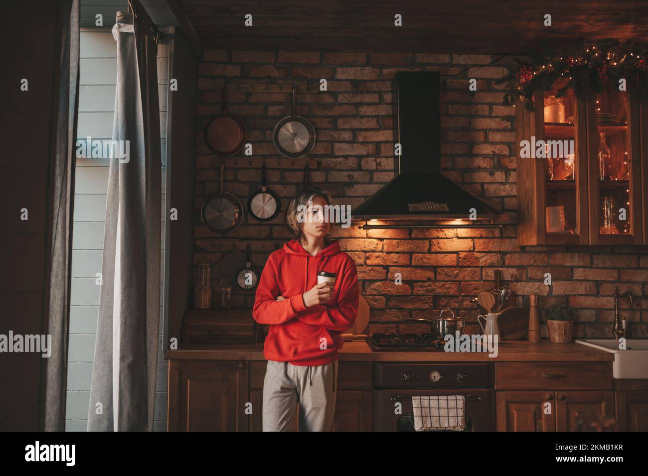 Young teen boy with long hair thoughtful look sad eyes negative mood ...