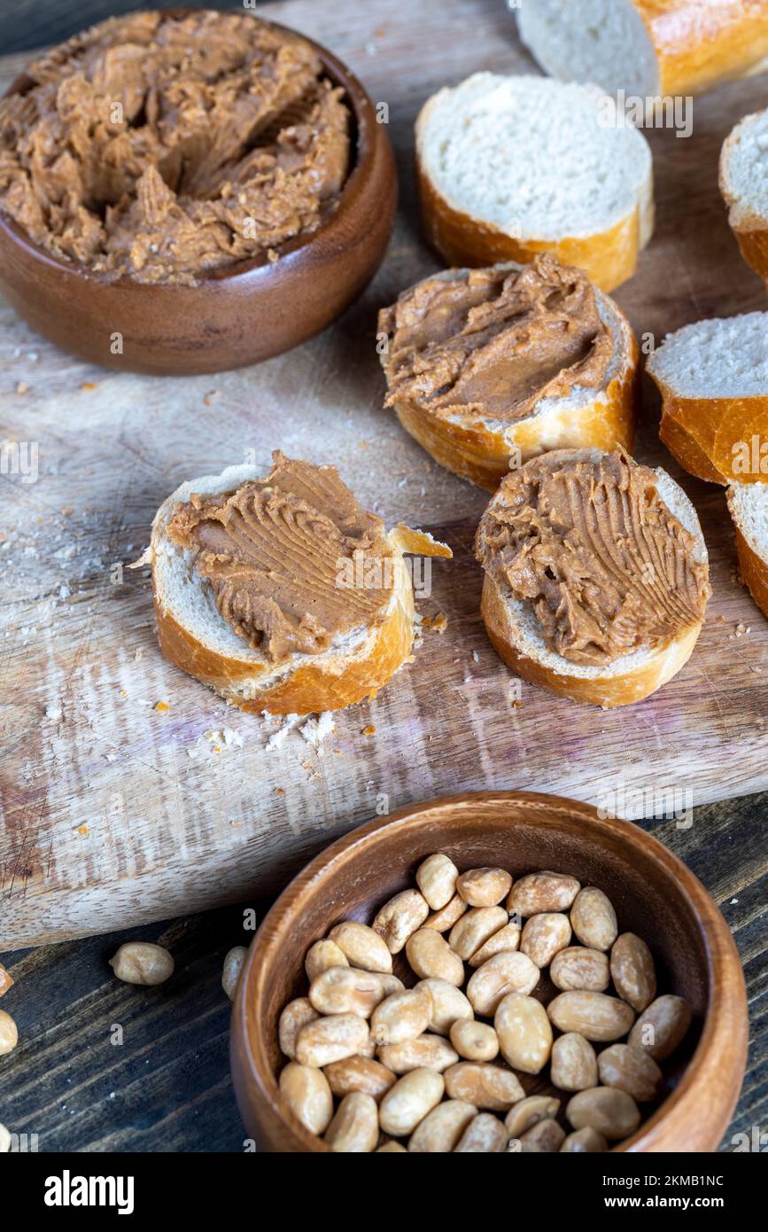 peanut paste with pieces of peanuts and white baguette, peanut butter ...