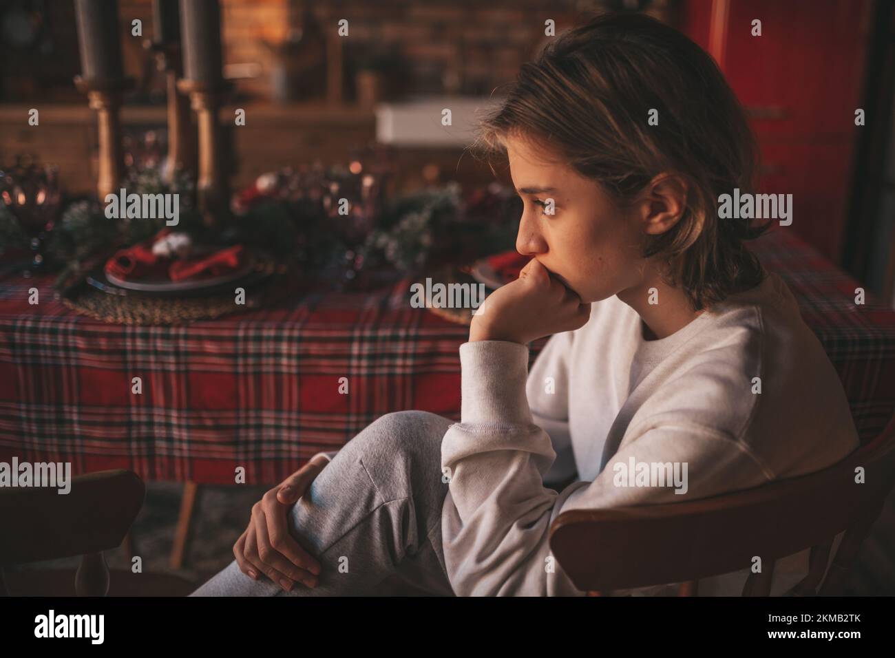 Young teen boy with long hair thoughtful look sad eyes negative mood ...