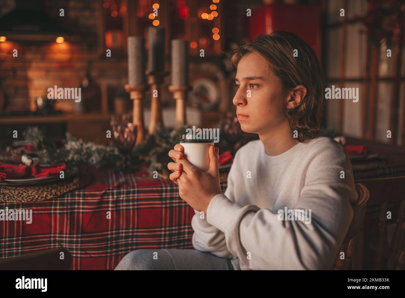 Young teen boy with long hair thoughtful look sad eyes negative mood ...