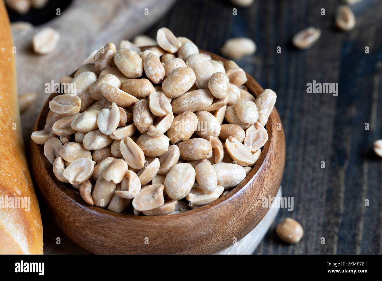 roasted peanuts peeled from the shell on a wooden table, peanuts fried ...