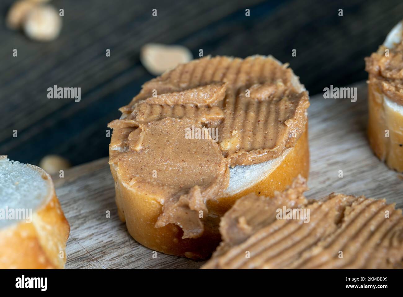sliced white bread with buttered peanut butter with pieces of crushed ...