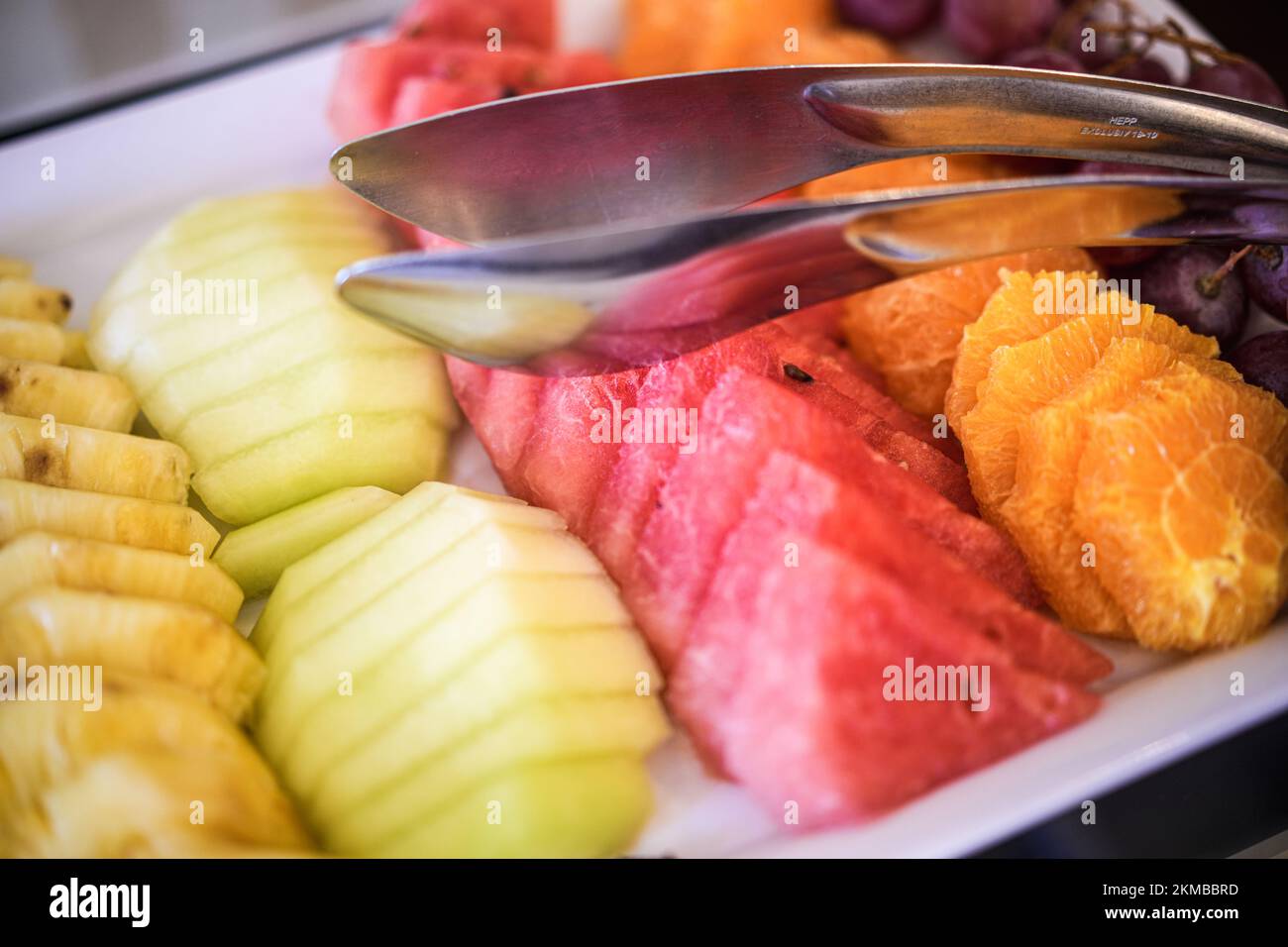 Sliced fruit mix on a plate, orange, watermelon, grape Stock Photo - Alamy