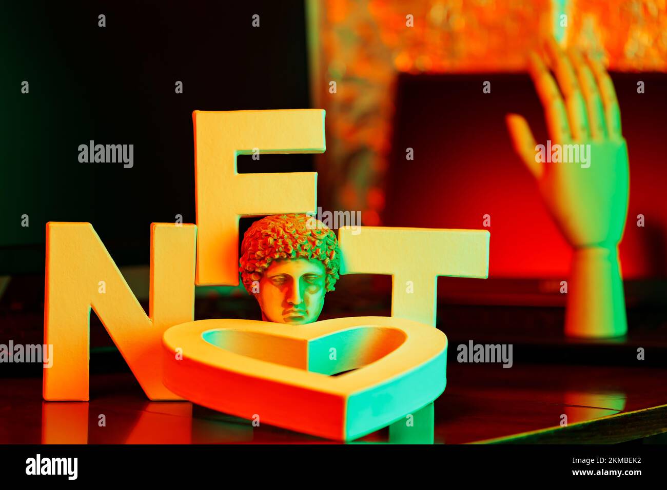 NFT (Non-Fungible Token) and artificial hand in orange-green light. NFT ...