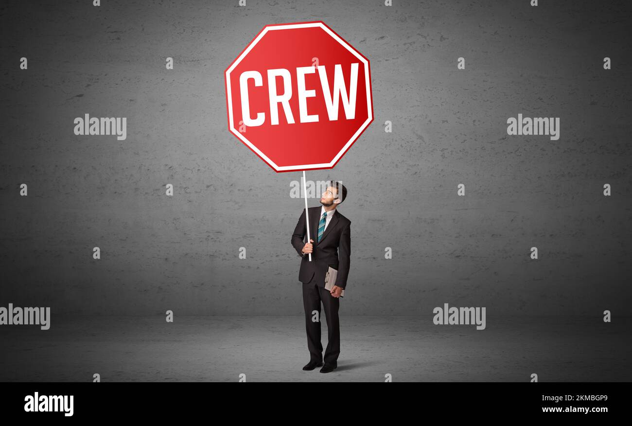 Young business person holding road sign Stock Photo - Alamy