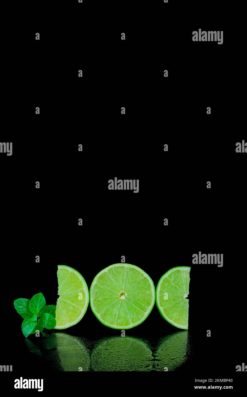 Still life, lemon and lime on black background Stock Photo - Alamy