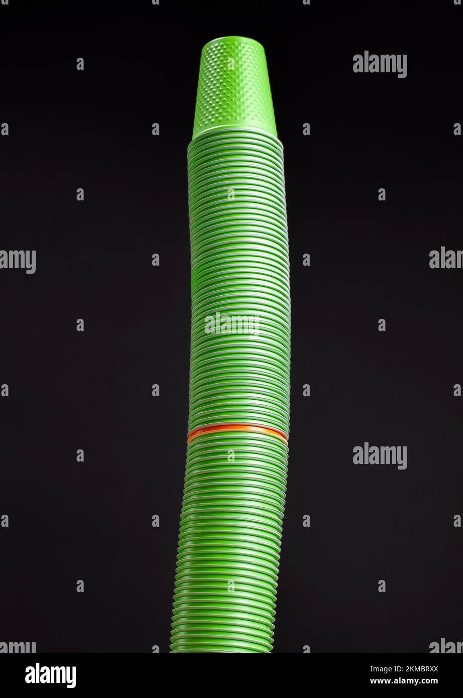 disposable plastic cups of green color, a group of clean new plastic ...