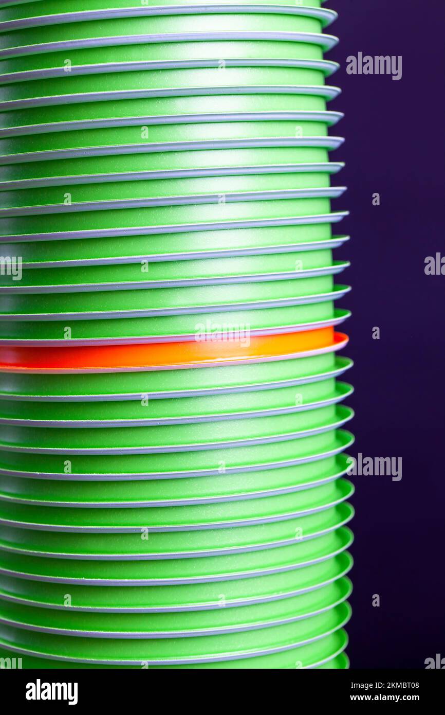 disposable plastic cups of green color, a group of clean new plastic ...