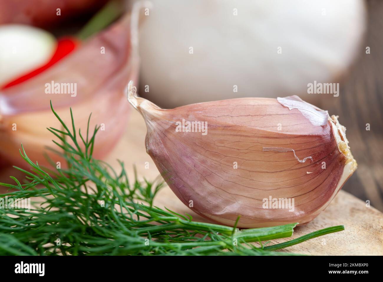 garlic cloves divided into several parts on a cutting board, garlic ...