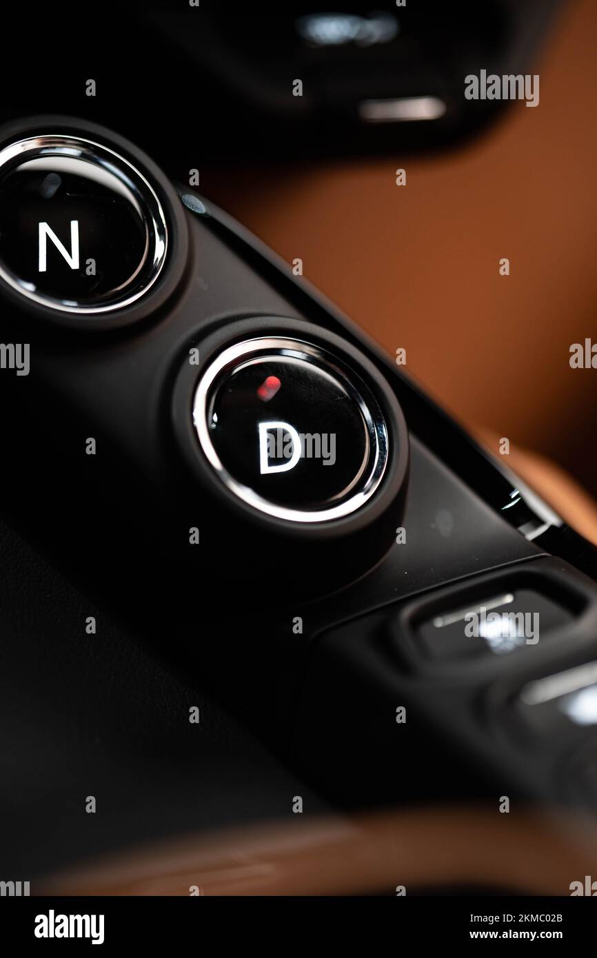 A vertical closeup of an Aston Martin Vantage drive mode selector ...
