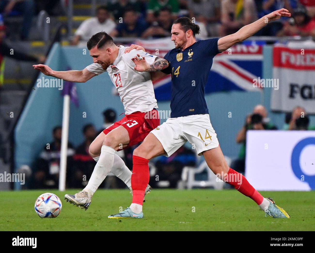 Doha, Qatar. 26th Nov, 2022. Pierre-Emile Hojbjerg (L) of Denmark vies ...