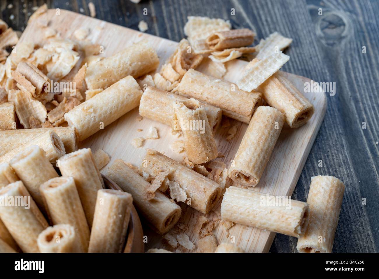 thin crispy waffles lie on a black table, sweet food for desserts Stock ...