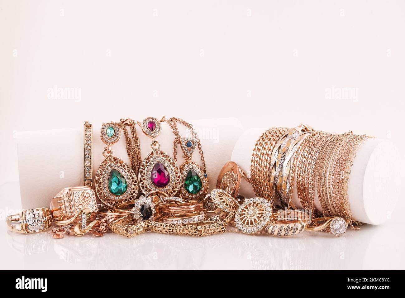 Photo of golden set with gems over white background Stock Photo - Alamy