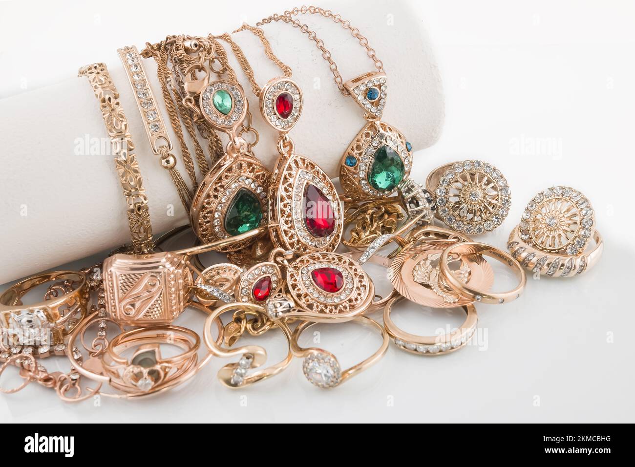 Photo of golden set with gems over white background Stock Photo - Alamy