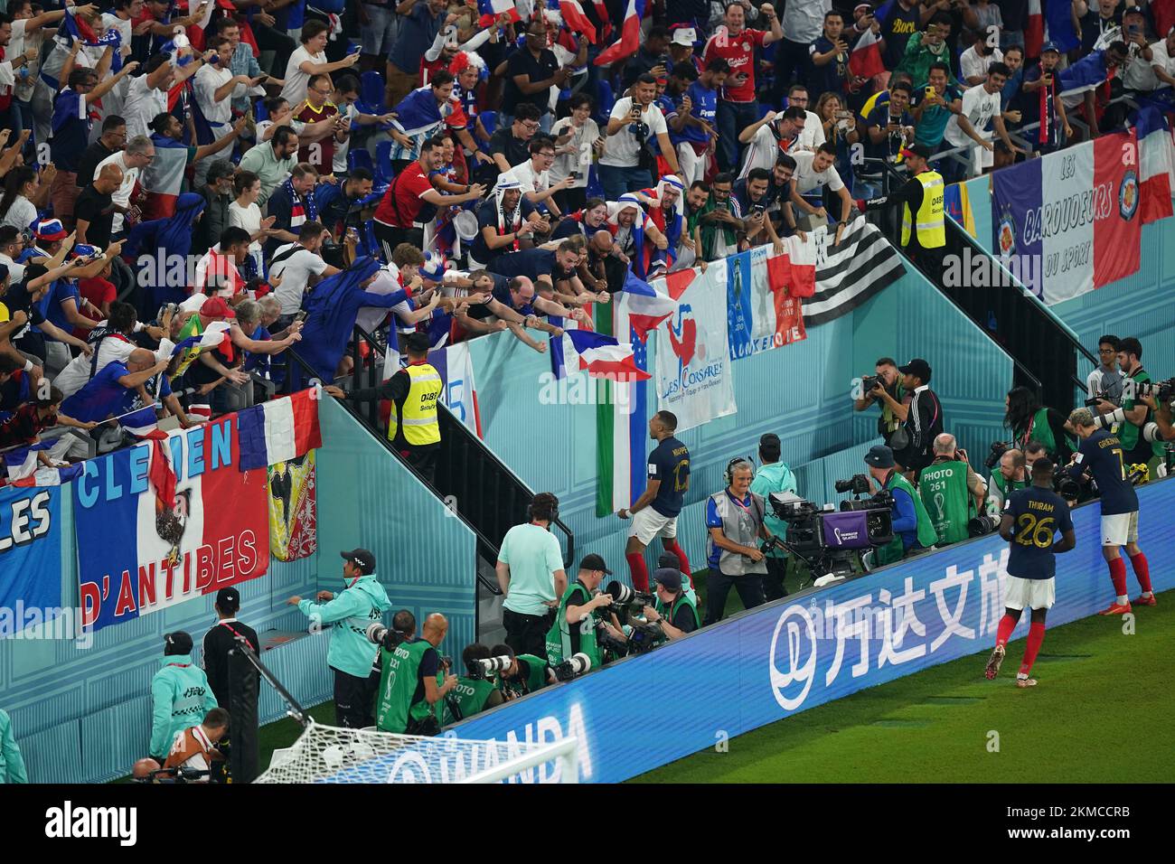 France's Kylian Mbappe jumps the hoardings to celebrate with the fans ...