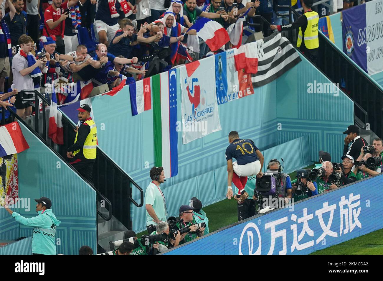 France's Kylian Mbappe jumps the hoardings to celebrate with the fans ...