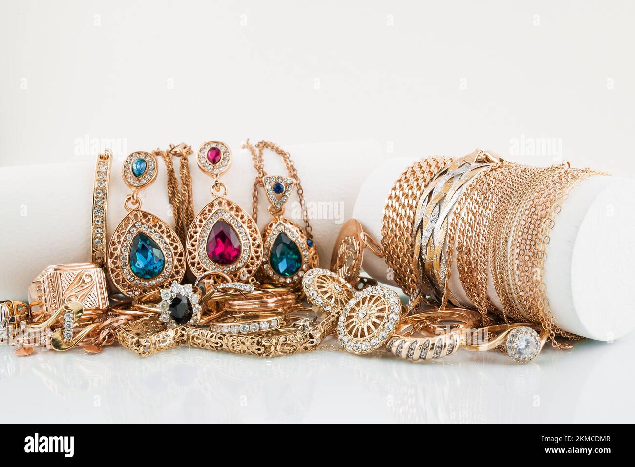 Photo of golden set with gems over white background Stock Photo - Alamy