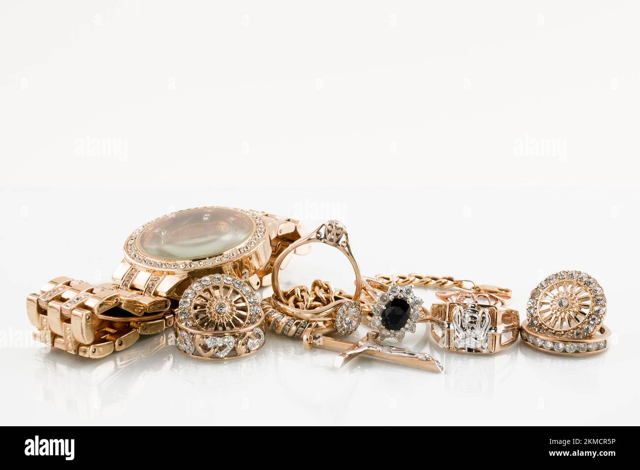 Photo of golden set with gems over white background Stock Photo - Alamy