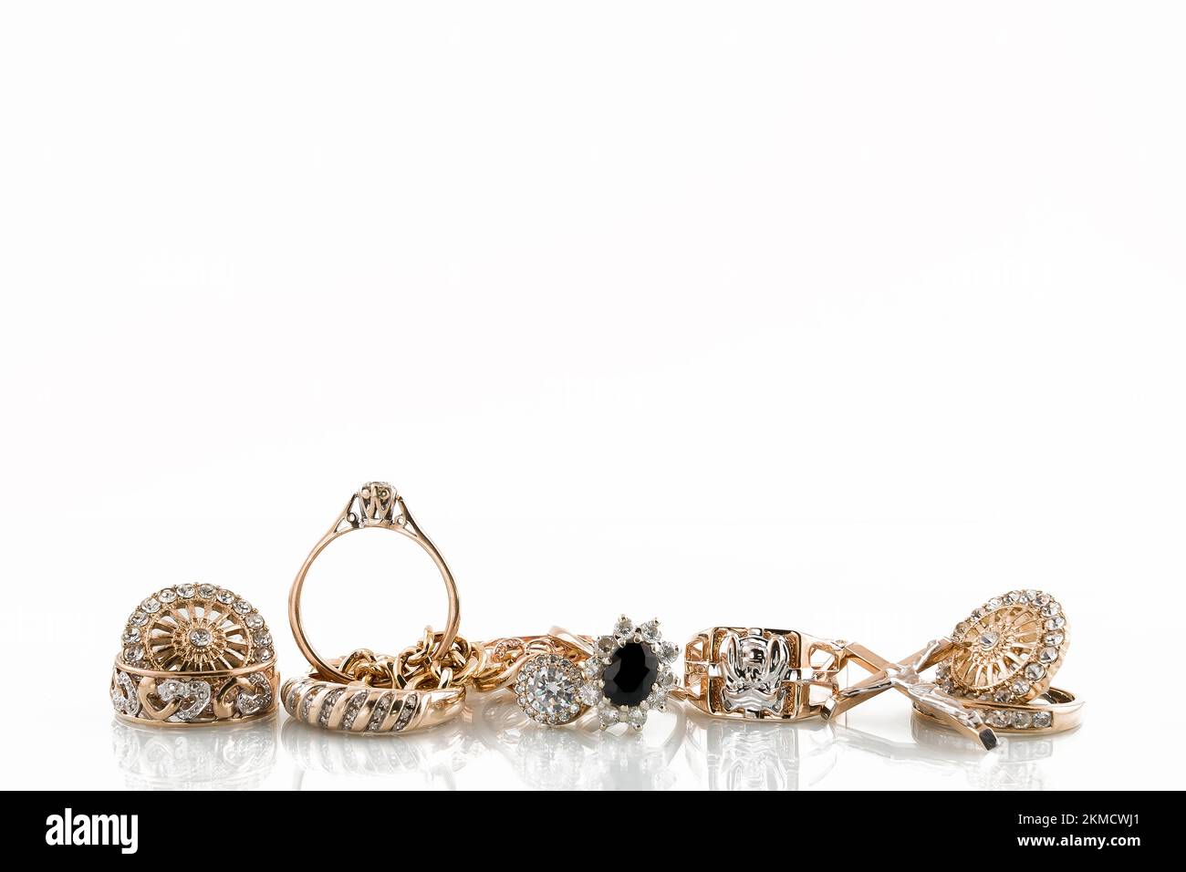 Photo of golden set with gems over white background Stock Photo - Alamy