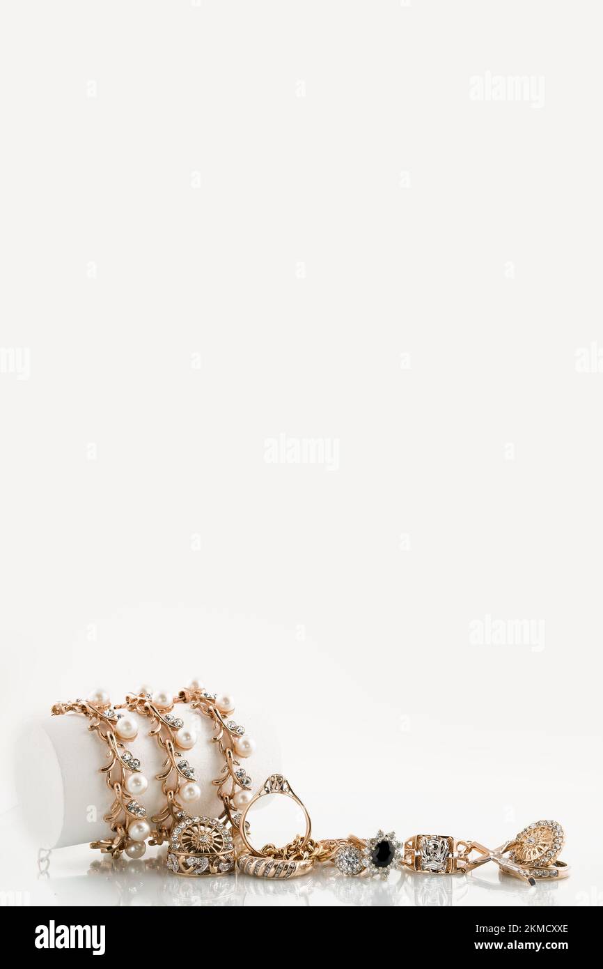 Photo of golden set with gems over white background Stock Photo - Alamy