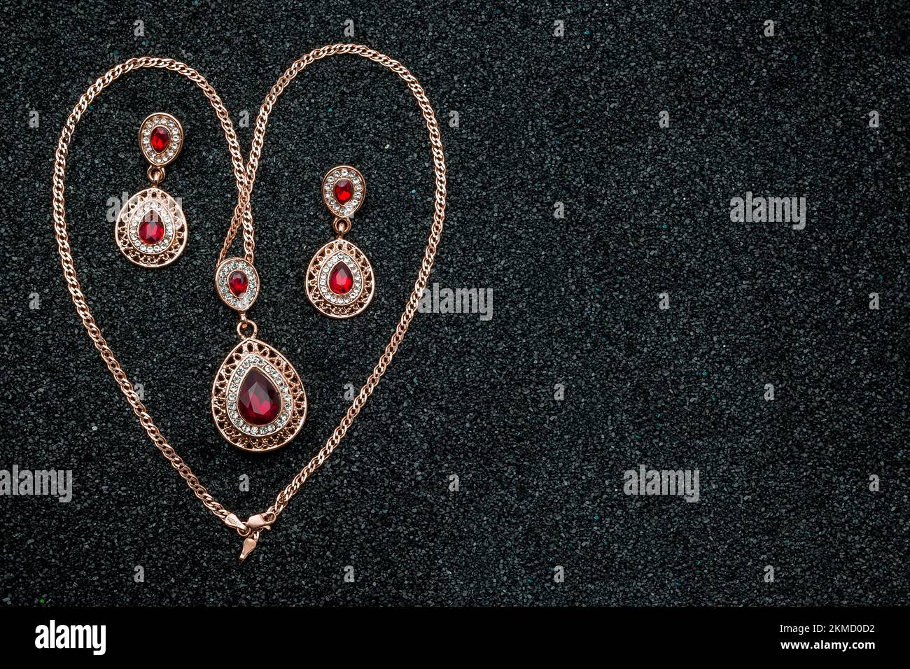 Photo of golden set with gems over dark background Stock Photo - Alamy