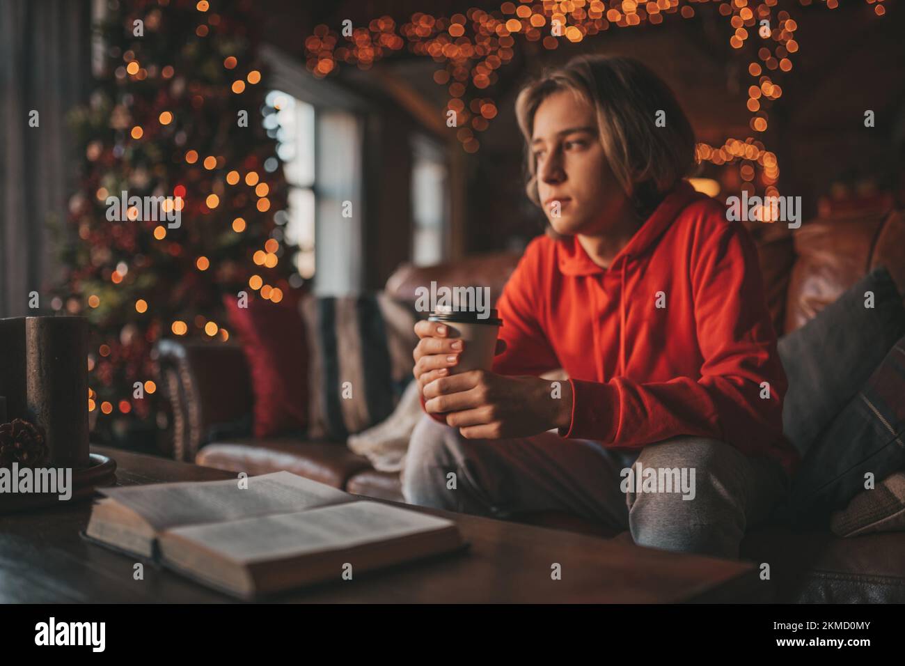 Young teen boy with long hair thoughtful look sad eyes negative mood ...