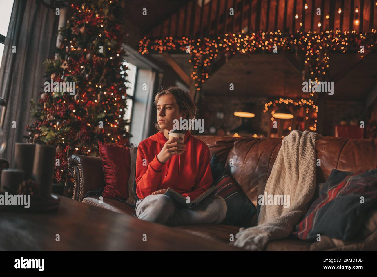 Young teen boy with long hair thoughtful look sad eyes negative mood ...