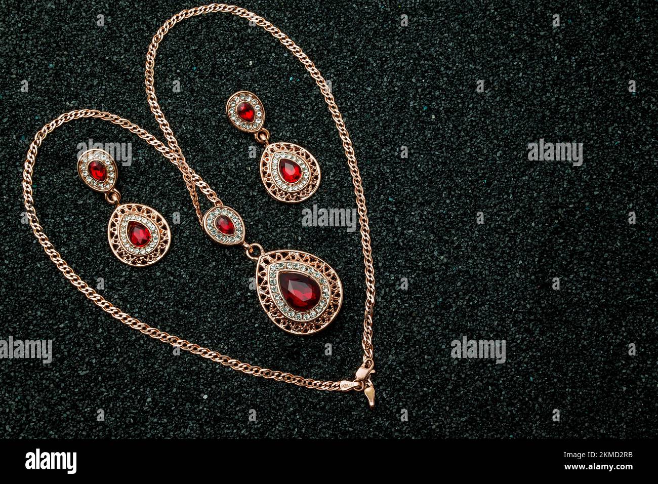 Photo of golden set with gems over dark background Stock Photo - Alamy