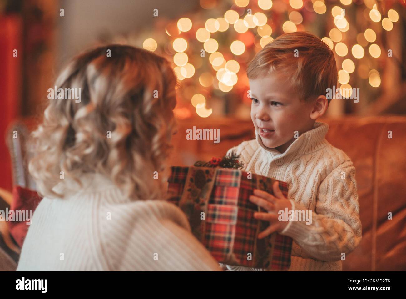 Portrait of happy family mom with small son in knitted beige sweaters ...