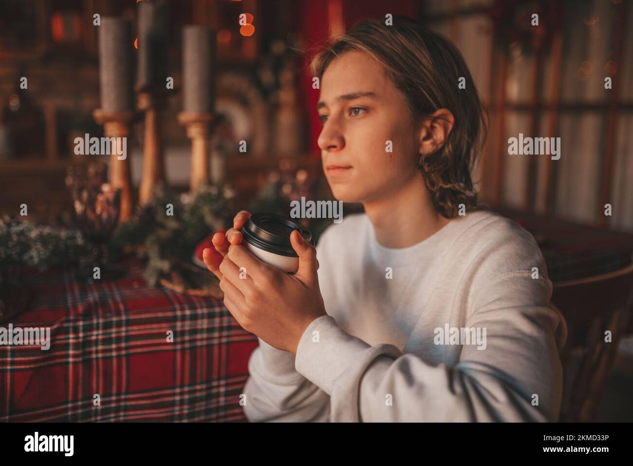 Young teen boy with long hair thoughtful look sad eyes negative mood ...